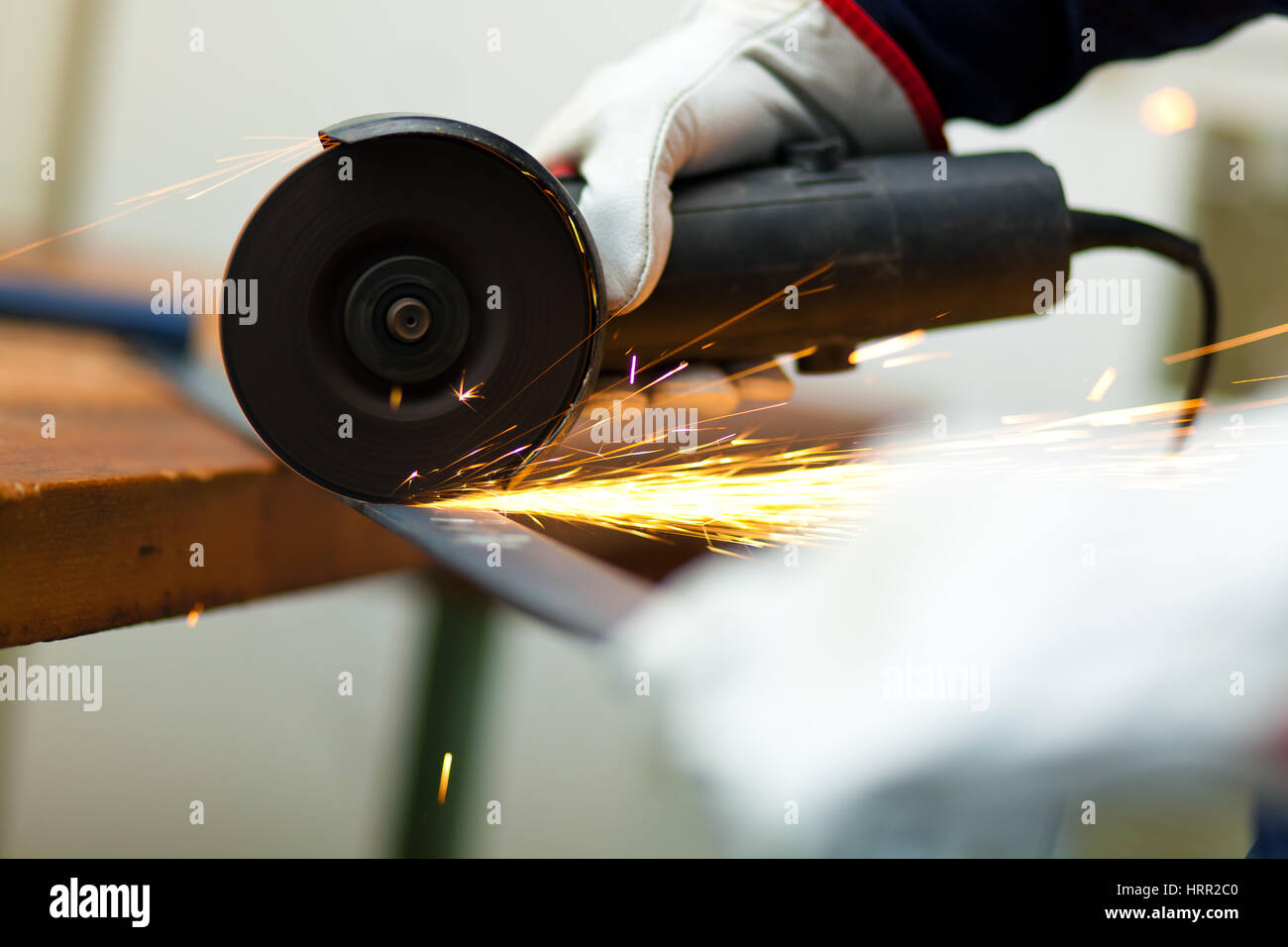 Worker grinding a metal plate Stock Photo - Alamy