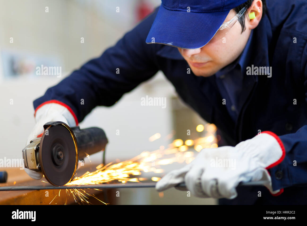 Worker grinding a metal plate Stock Photo - Alamy
