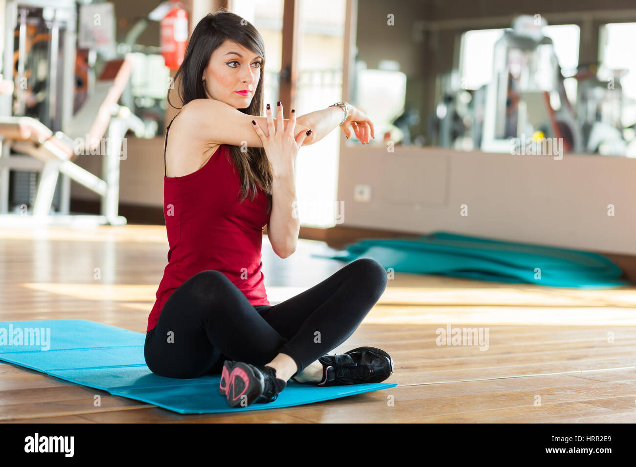 Beautiful woman doing stretching in a gym Stock Photo - Alamy