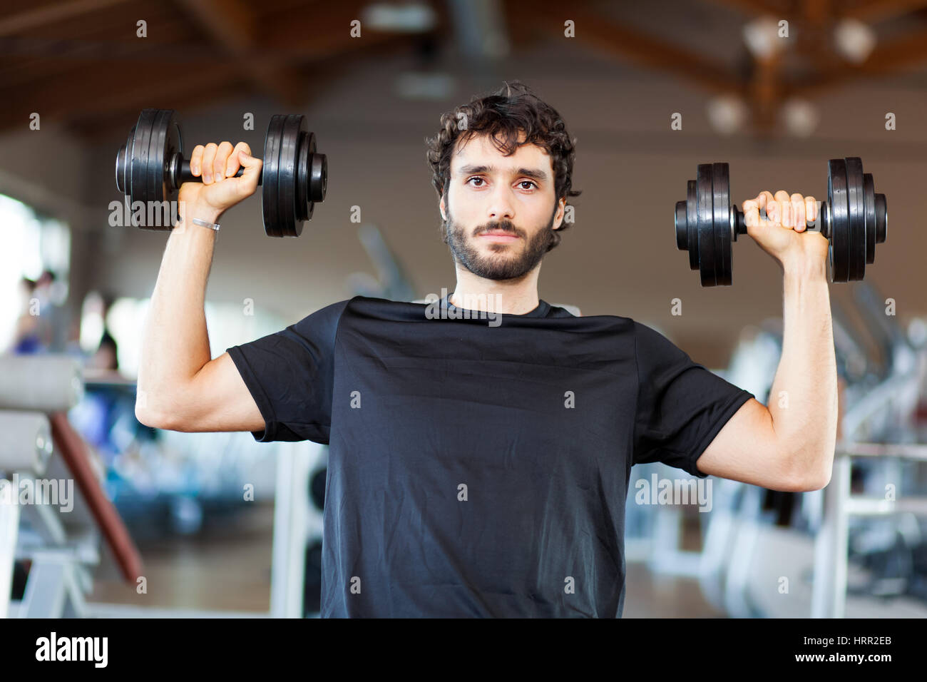 Man lifting weights Stock Photo - Alamy