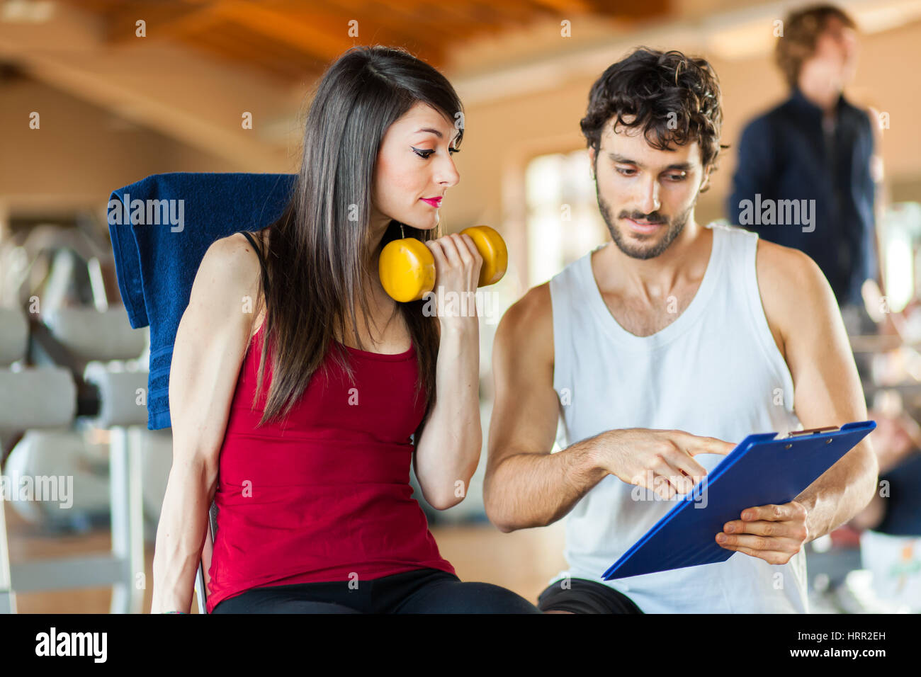 Woman working out in a gym with her personal trainer Stock Photo - Alamy