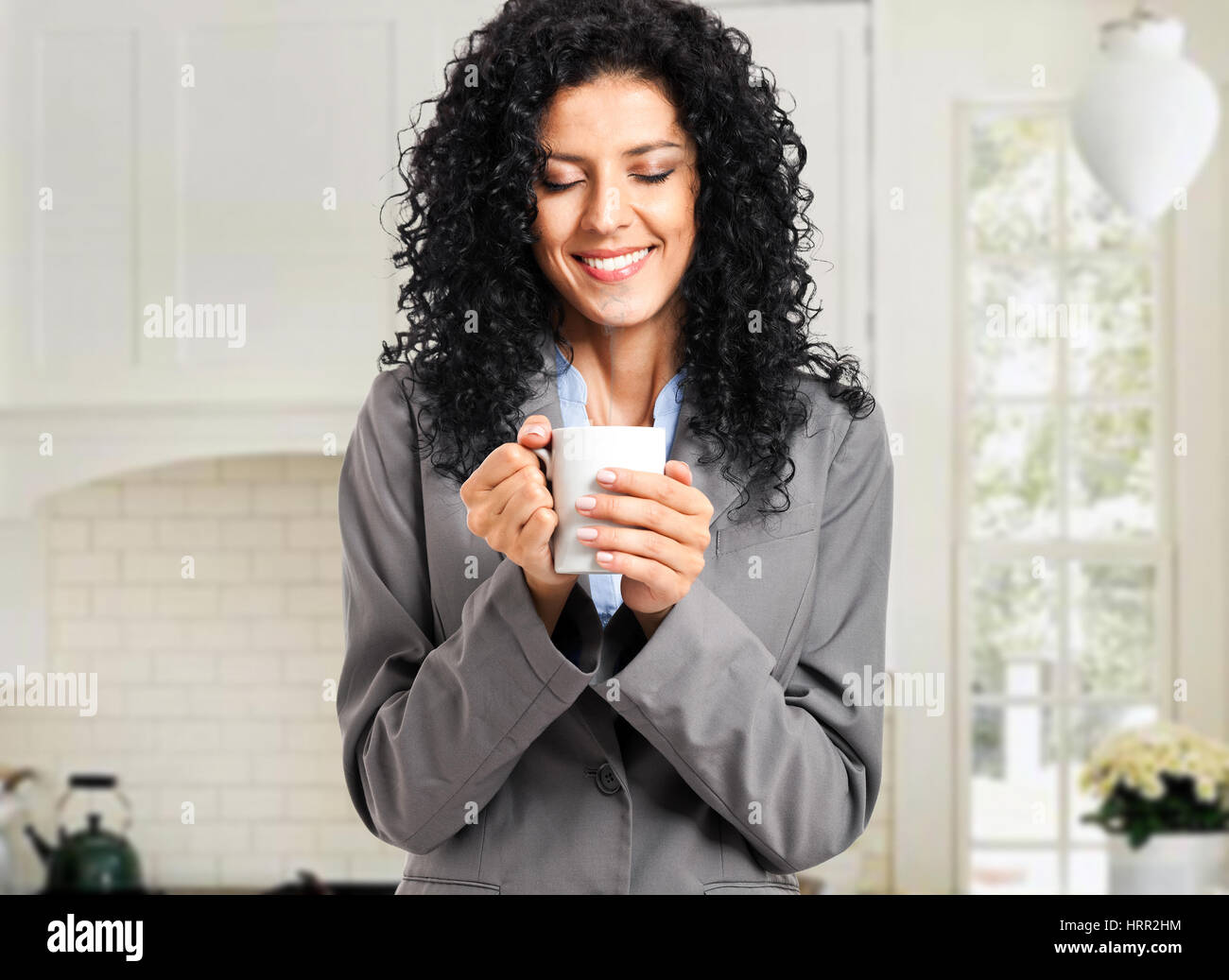 Young woman drinking a cup of coffee at home Stock Photo - Alamy