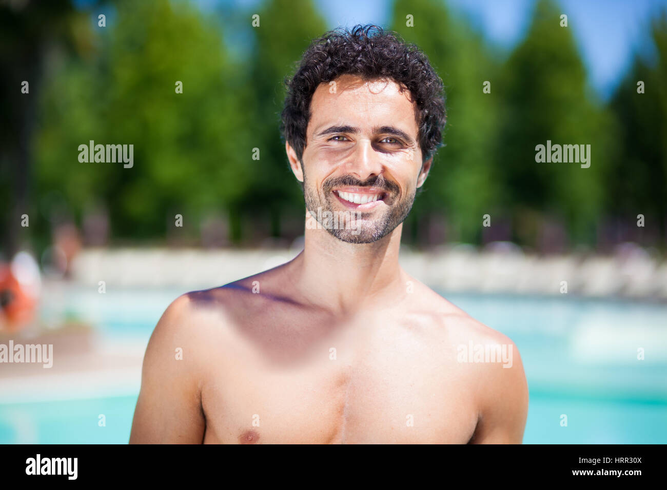 Handsome man enjoying the summer in a swimming pool Stock Photo - Alamy