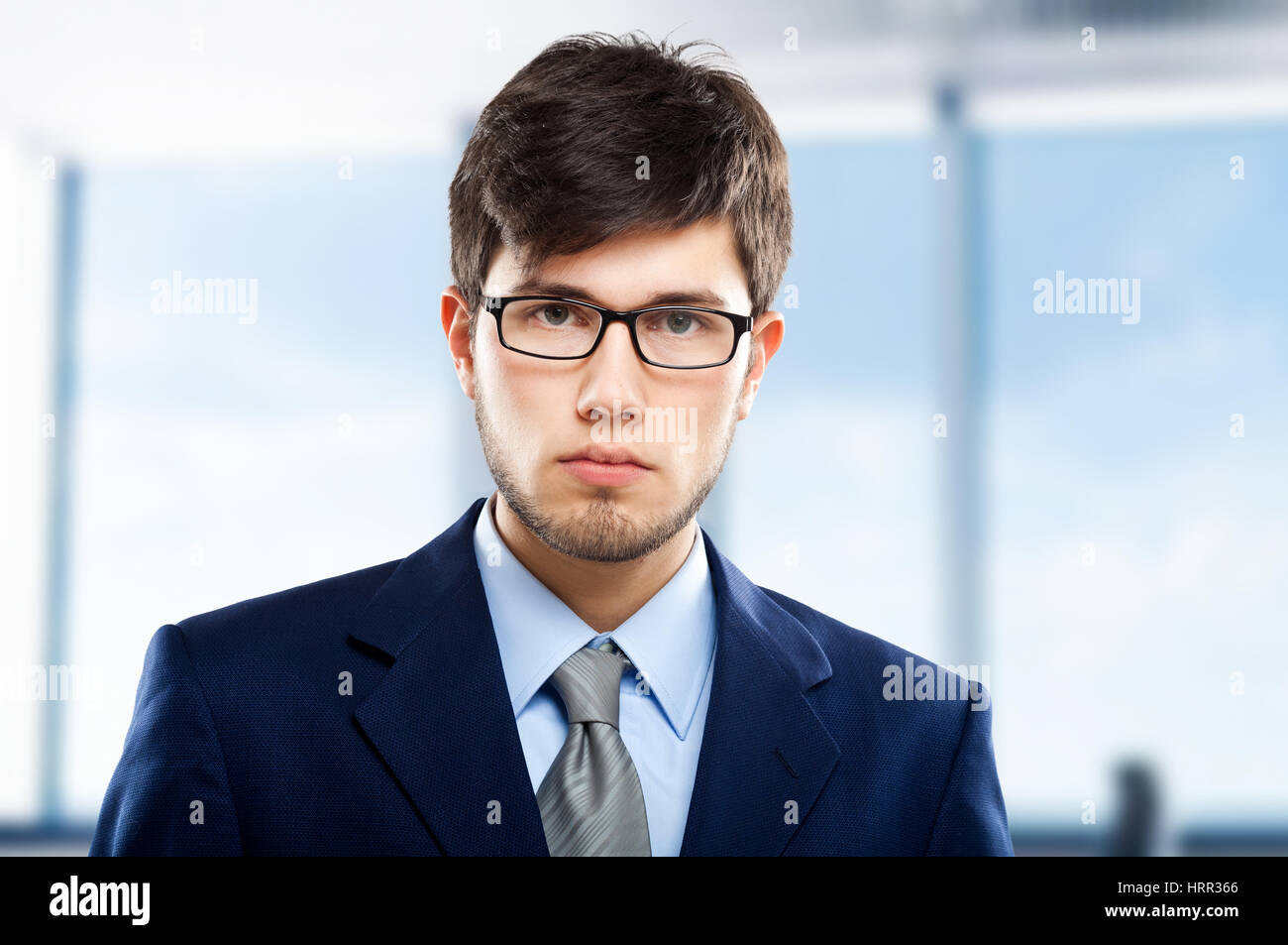 Handsome manager against blurry background Stock Photo - Alamy