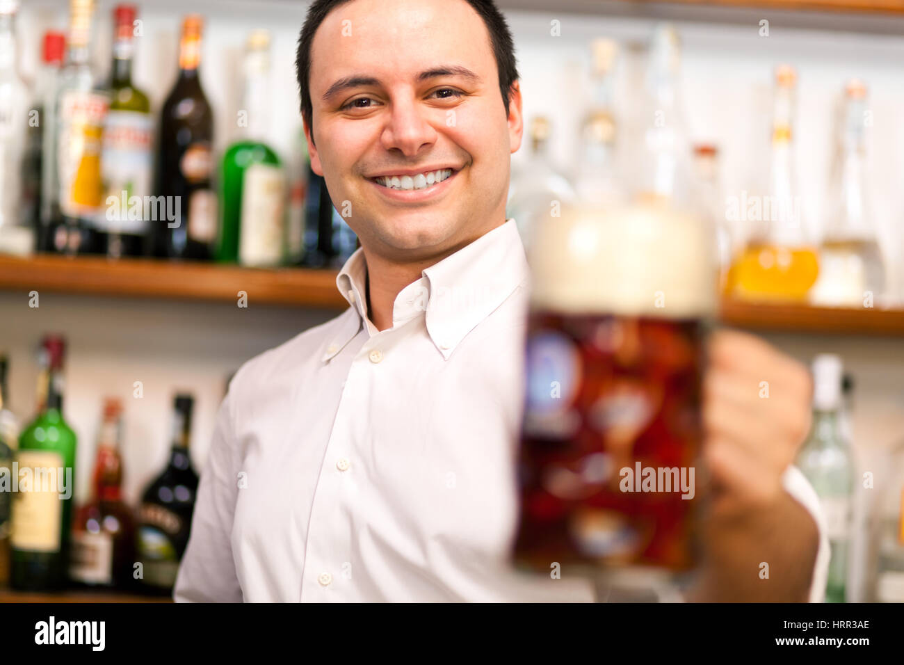 Bartender serving a beer Stock Photo - Alamy