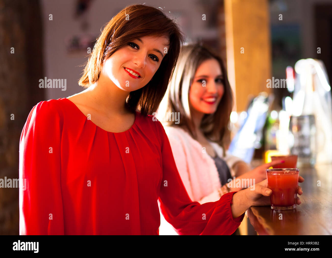 Friends having a round of drinks in a pub Stock Photo - Alamy