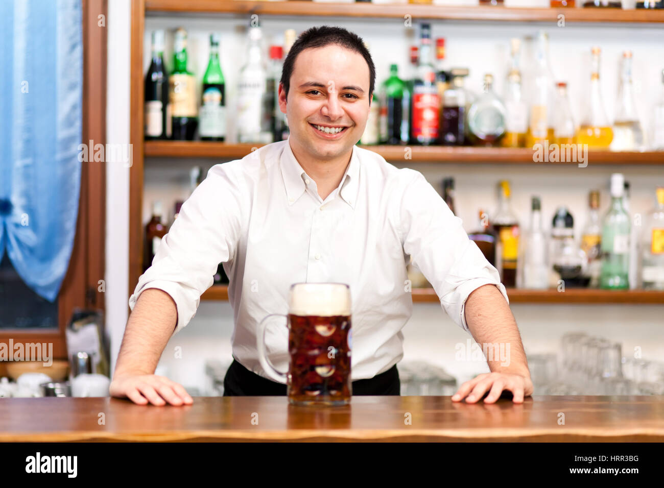 Bartender serving a beer Stock Photo - Alamy