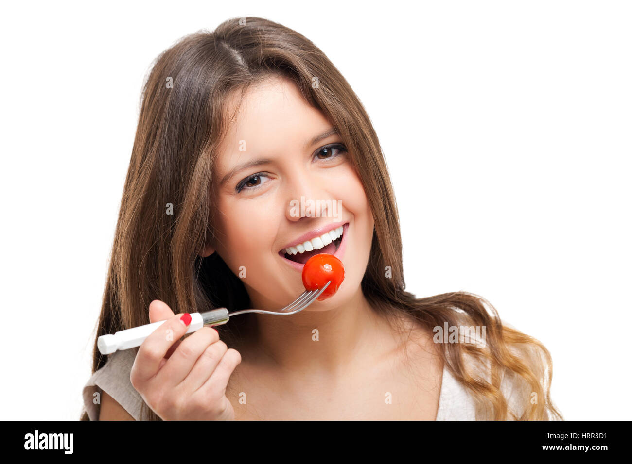 Young woman eating a tomato Stock Photo - Alamy
