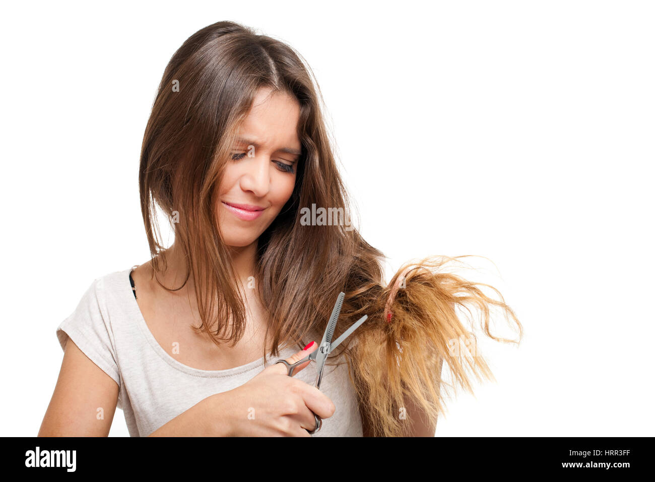 Young woman looking at split ends. Damaged long hair Stock Photo - Alamy