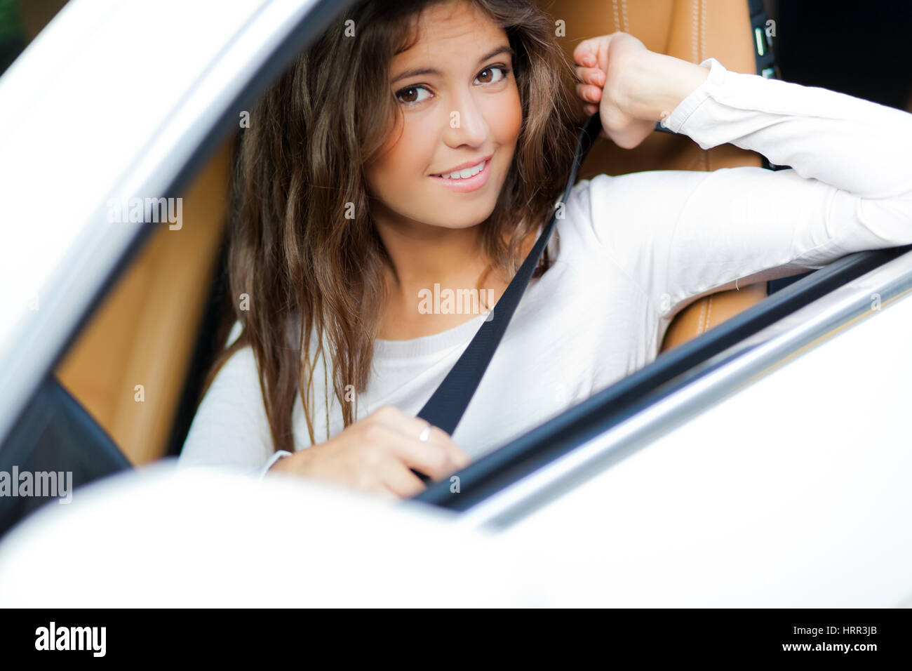 Beautiful young woman driving her car Stock Photo - Alamy