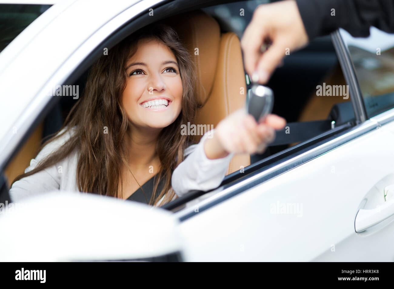 Young woman receiving the keys of her new car Stock Photo - Alamy