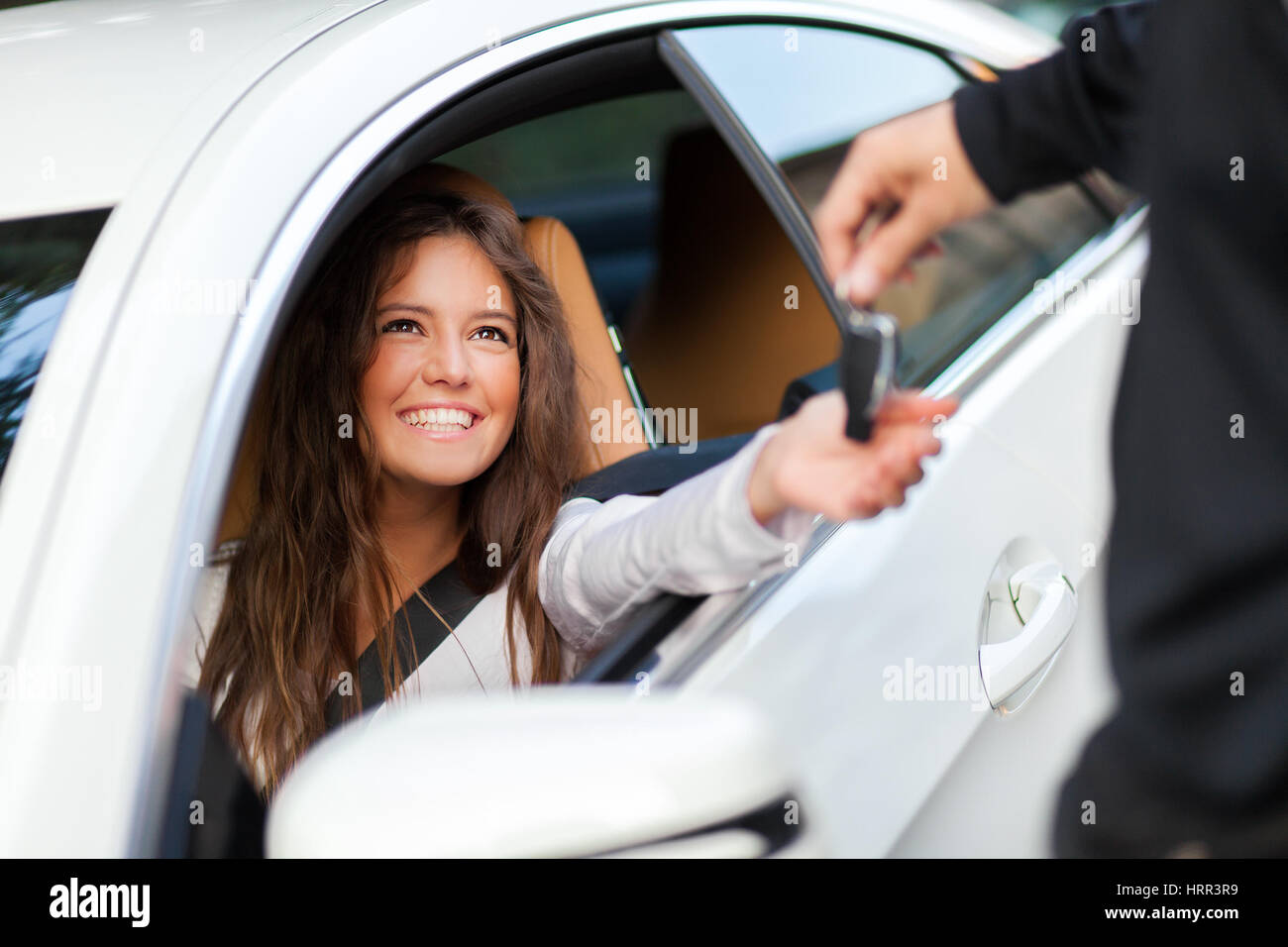 Young woman receiving the keys of her new car Stock Photo - Alamy