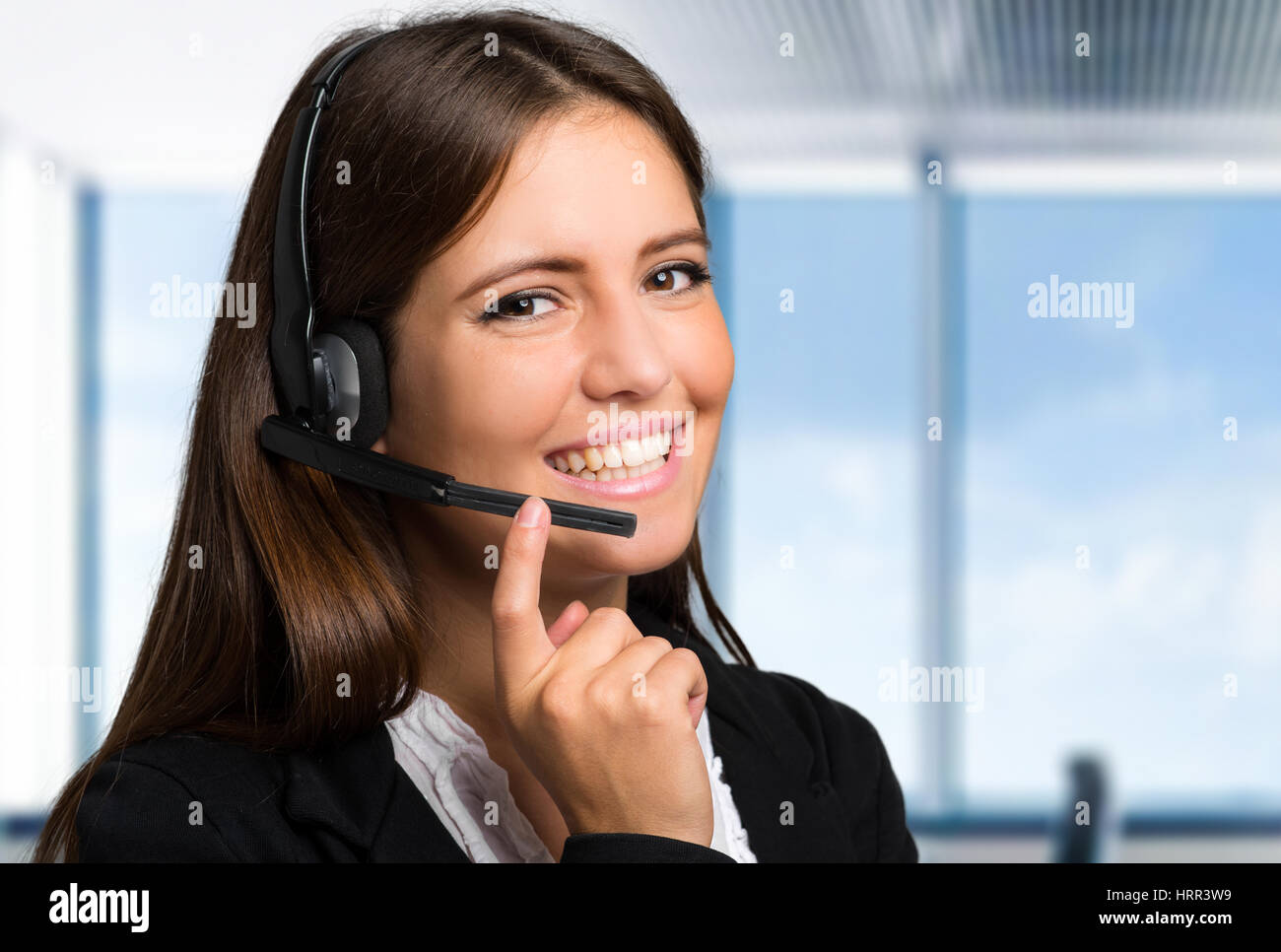 Female customer support operator with headset and smiling Stock Photo - Alamy