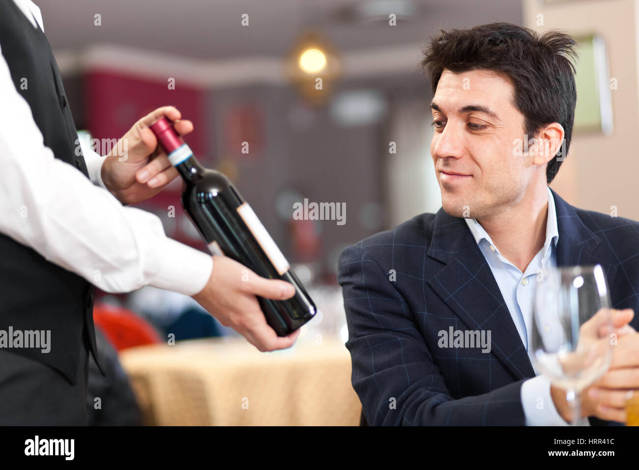 Man choosing wine in a restaurant Stock Photo - Alamy