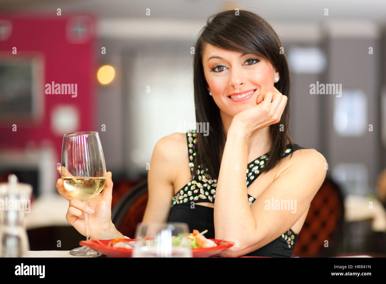 Woman having dinner in a restaurant Stock Photo - Alamy