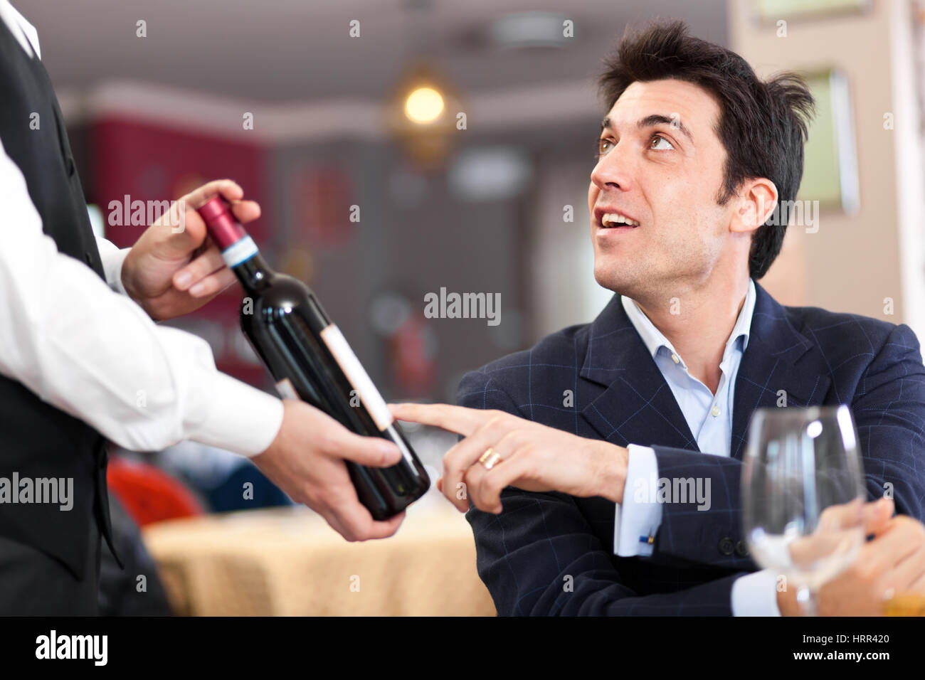 Man choosing wine in a restaurant Stock Photo - Alamy