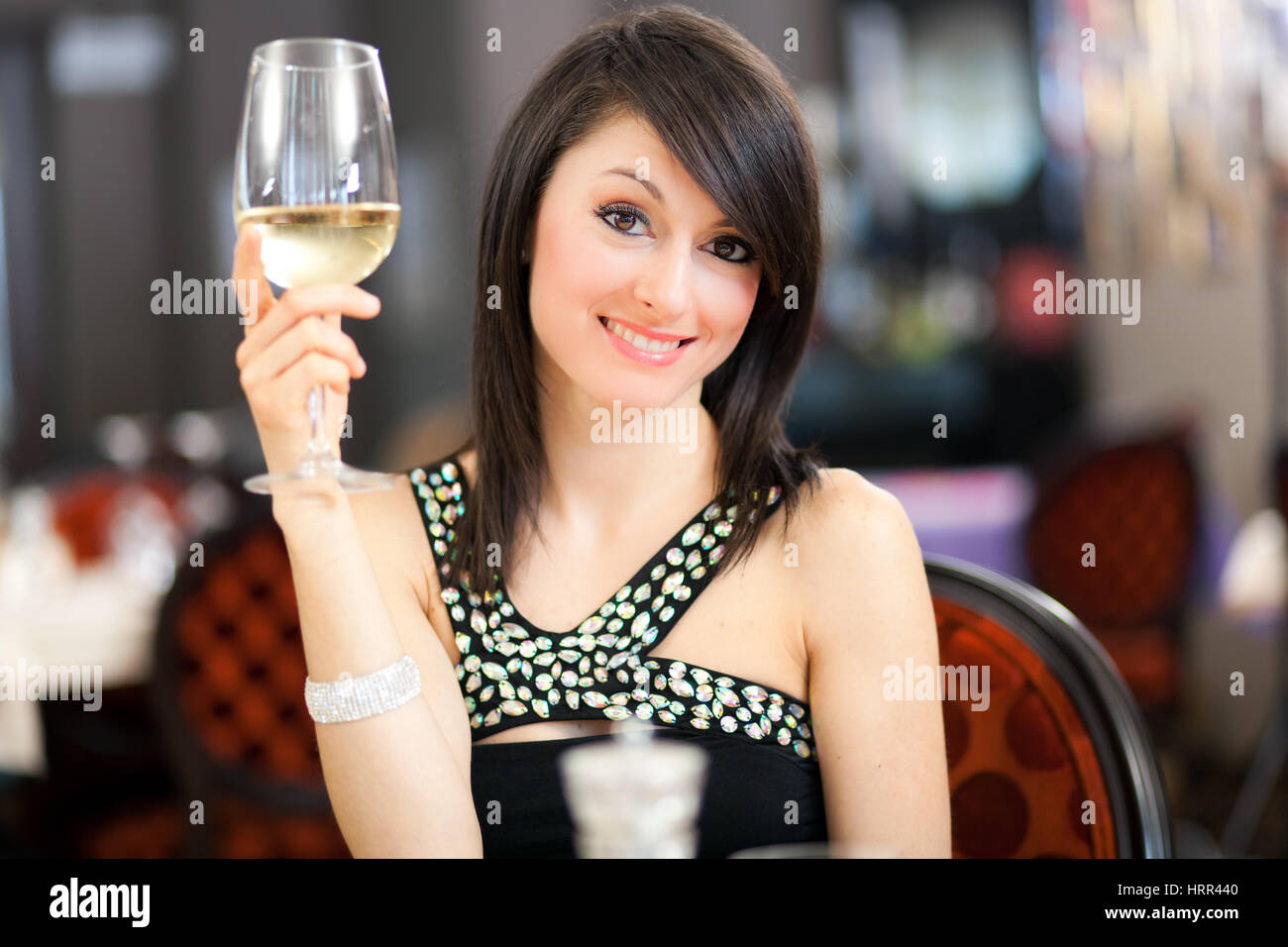 Beautiful woman drinking wine at the restaurant Stock Photo - Alamy