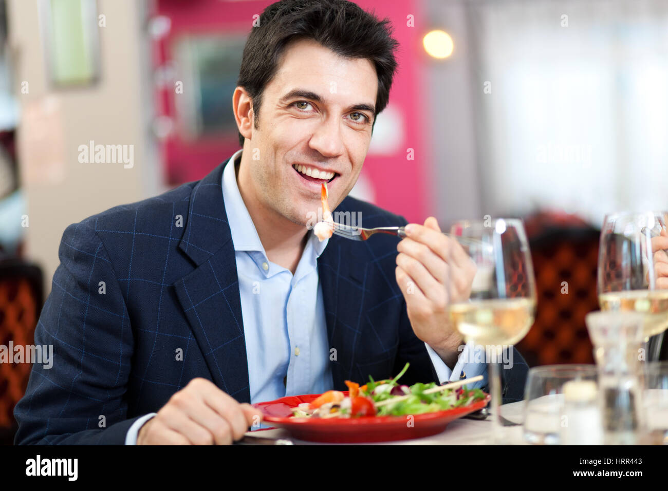 Handsome man eating at the restaurant Stock Photo - Alamy