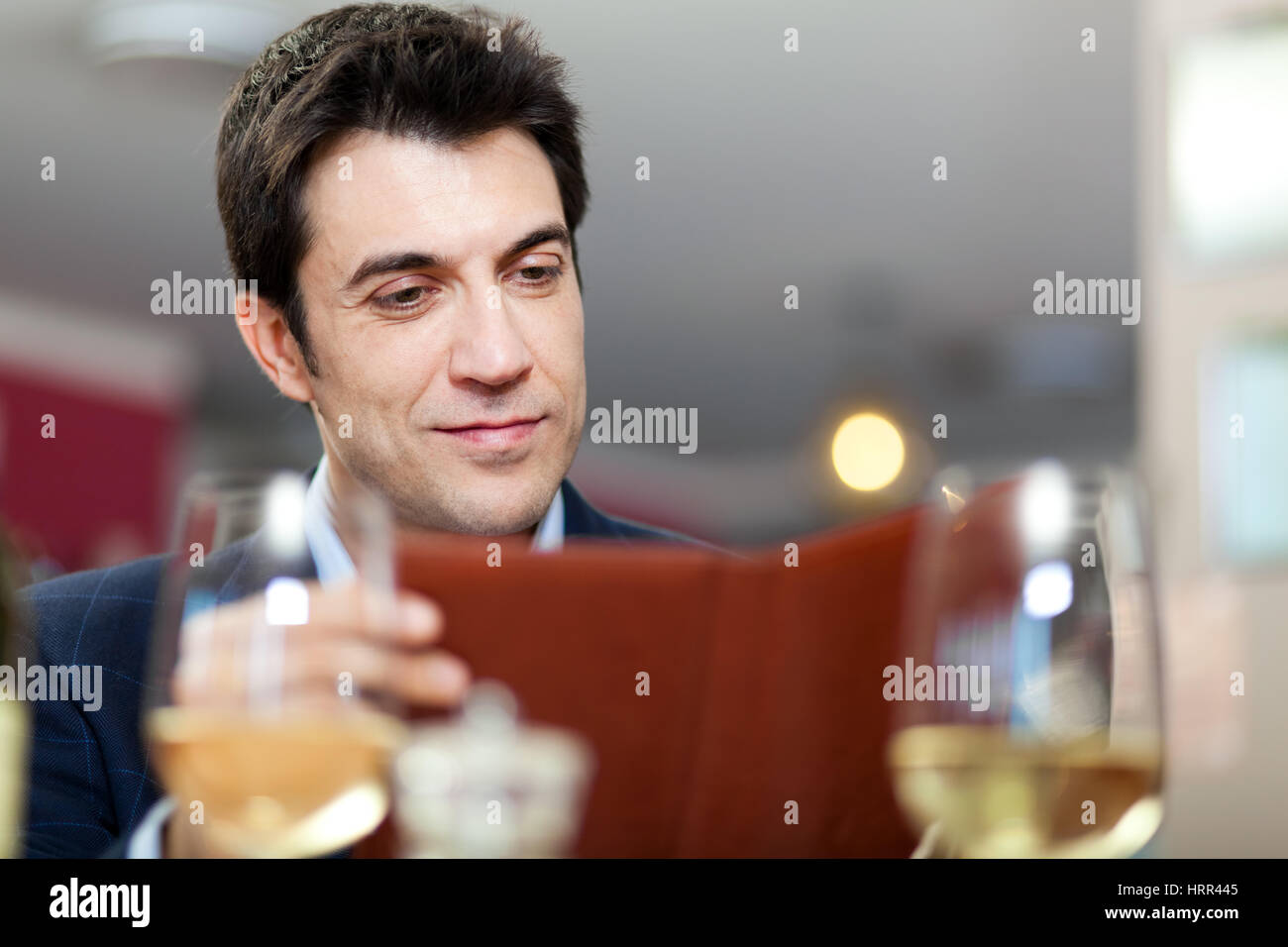 Man looking at a menu in the restaurant Stock Photo - Alamy