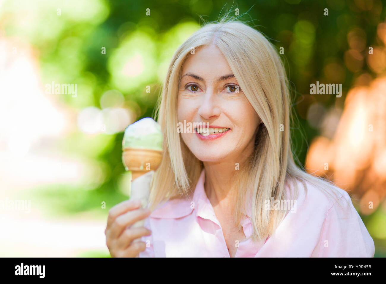 Old woman eating an ice cream cone hi-res stock photography and images ...