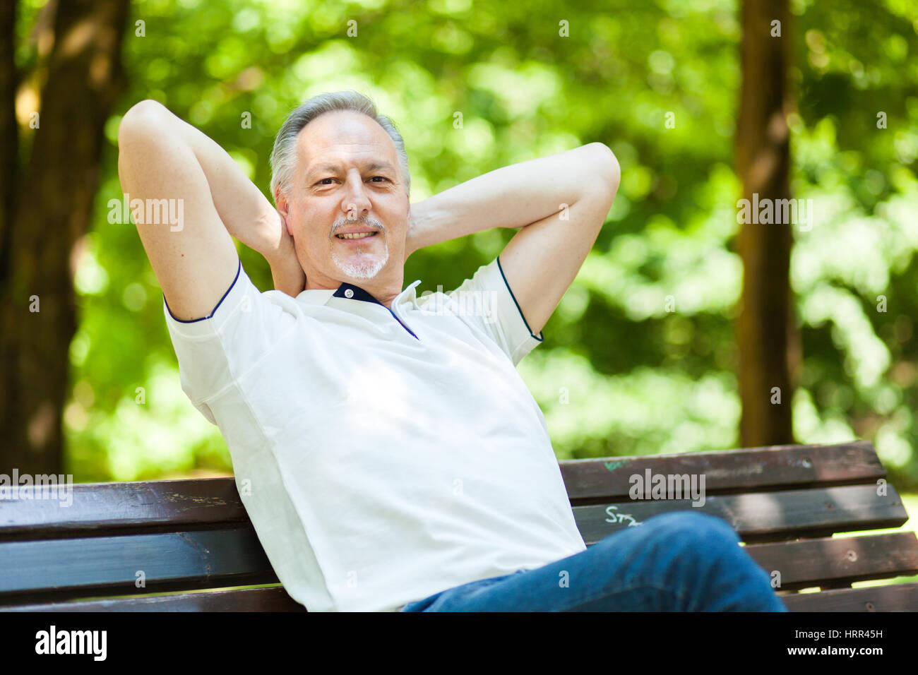 Senior man relaxing at the park Stock Photo - Alamy