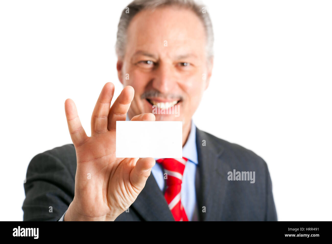 Smiling businessman holding a business card Stock Photo - Alamy
