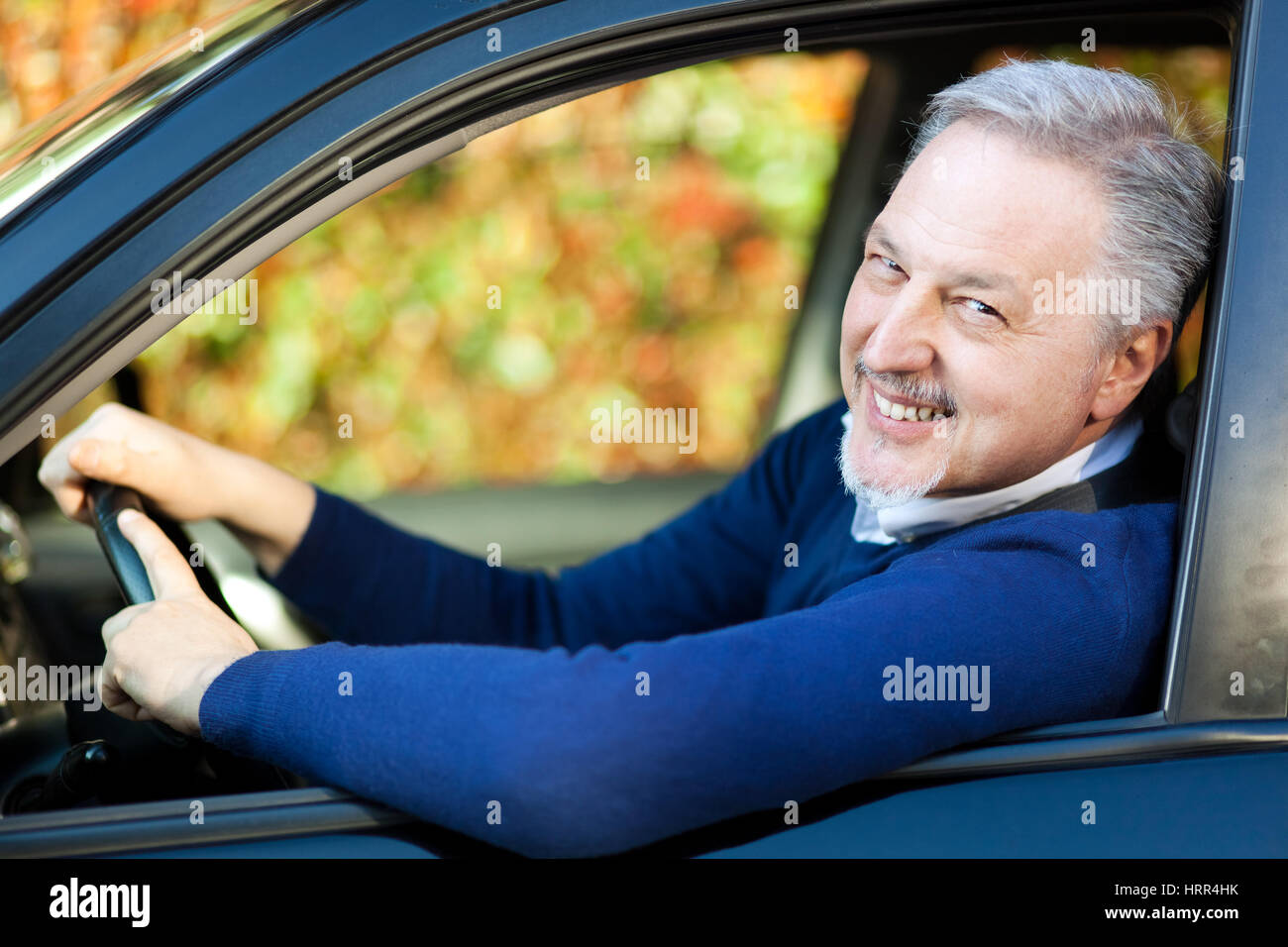 Mature man driving his car Stock Photo - Alamy