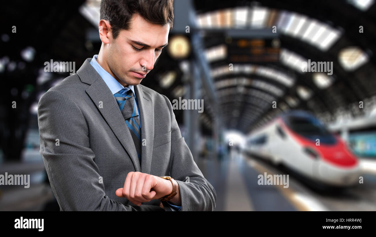 Man waiting for the train to arrive in a railroad station Stock Photo ...