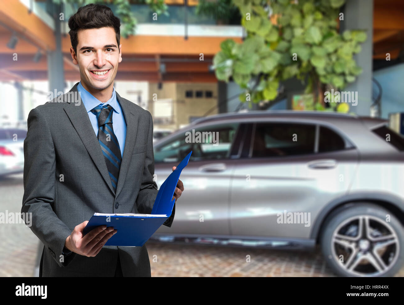 Handsome smiling car dealer portrait Stock Photo - Alamy