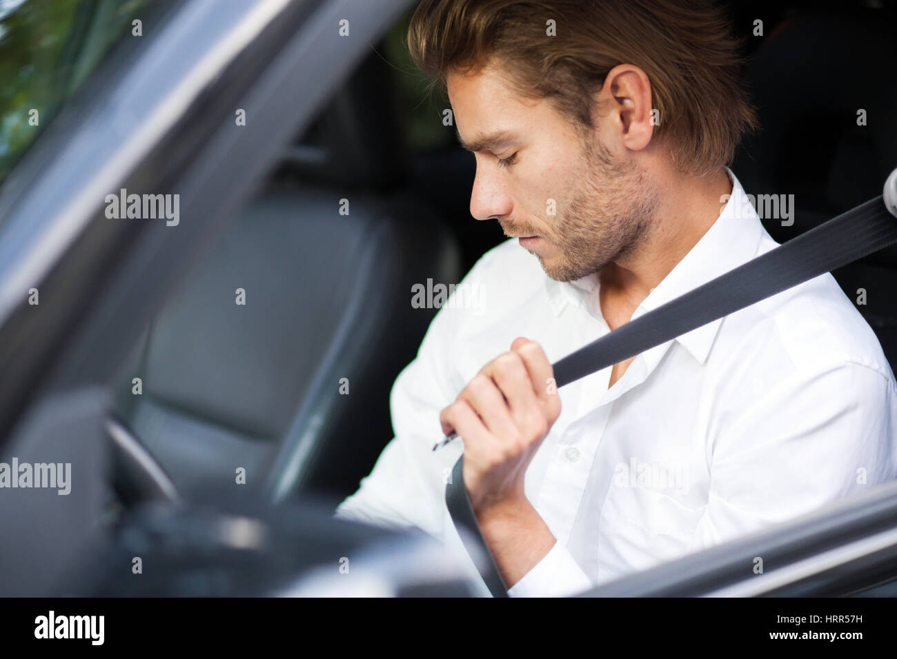 Man fastening his safety belt Stock Photo - Alamy