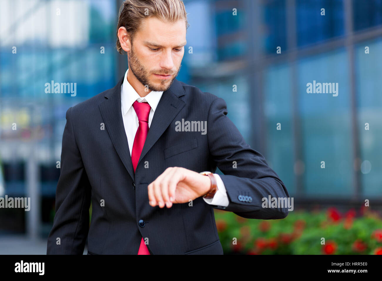 Businessman checking time Stock Photo - Alamy