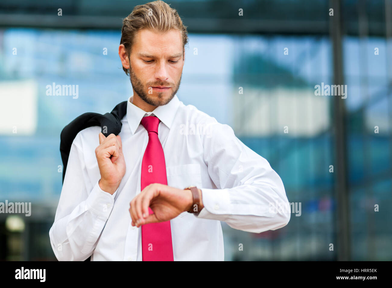 Businessman checking time Stock Photo - Alamy