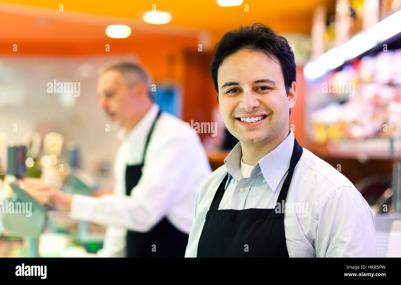 Shopkeeper working in his grocery store Stock Photo - Alamy