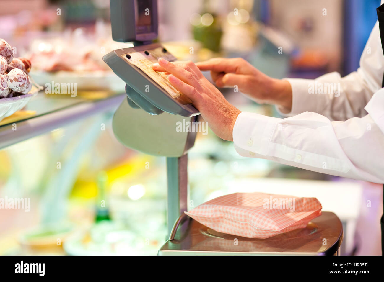 Shopkeeper cheking the food weight Stock Photo - Alamy
