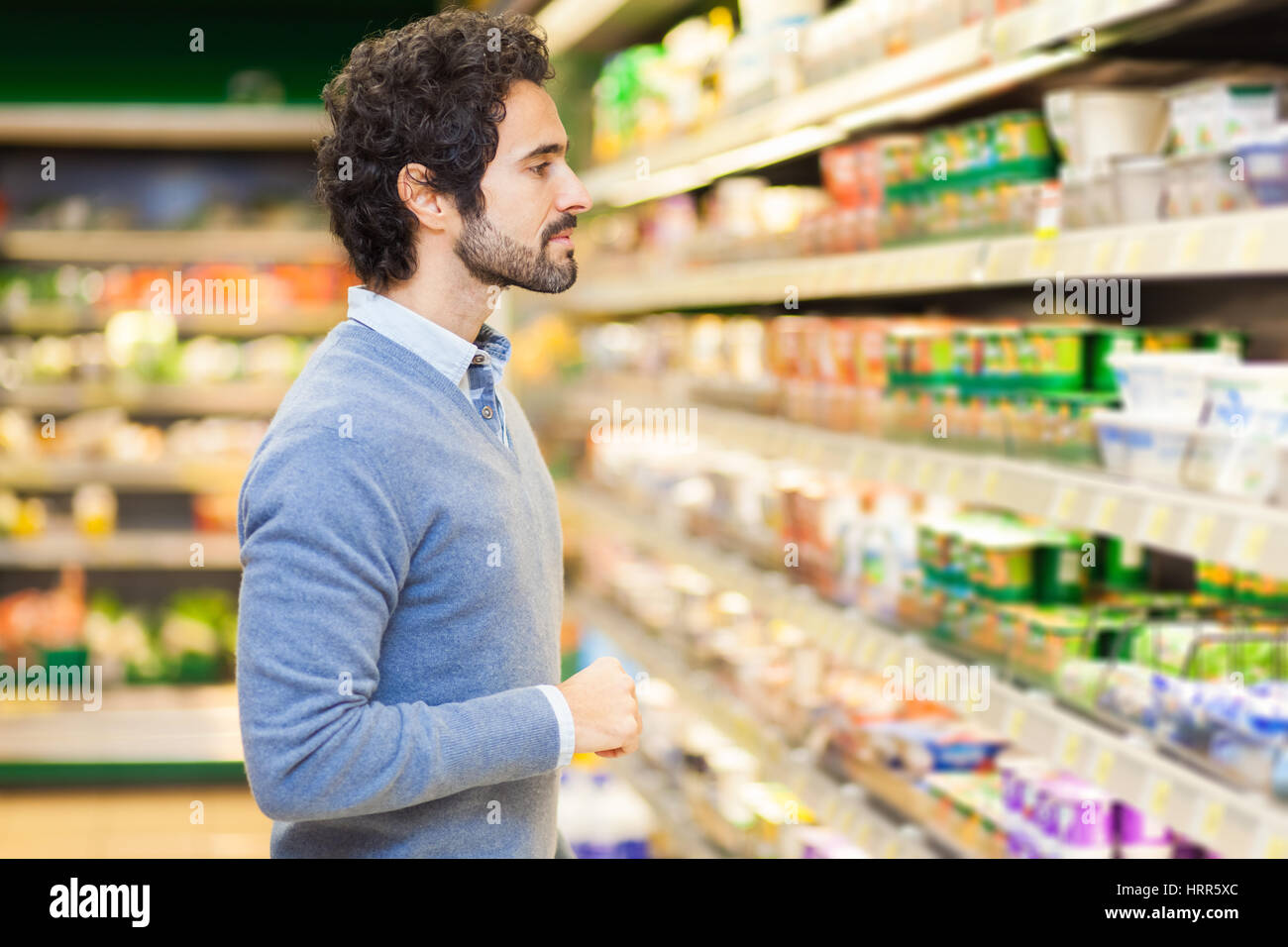 Attractive man shopping in a supermarket Stock Photo - Alamy