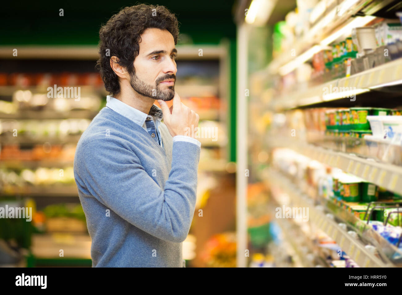 Attractive man shopping in a supermarket Stock Photo - Alamy