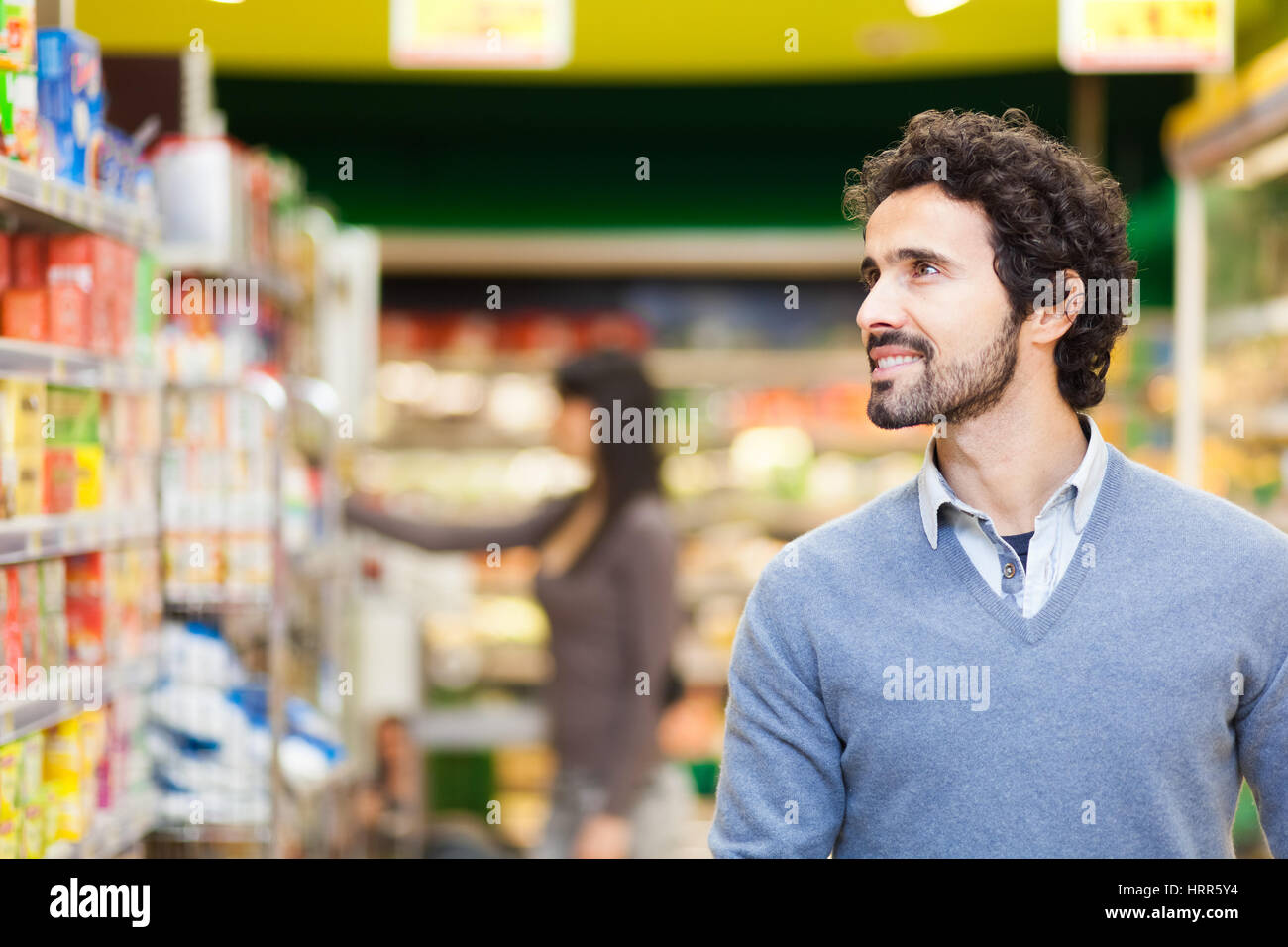Handsome man shopping in a supermarket Stock Photo - Alamy