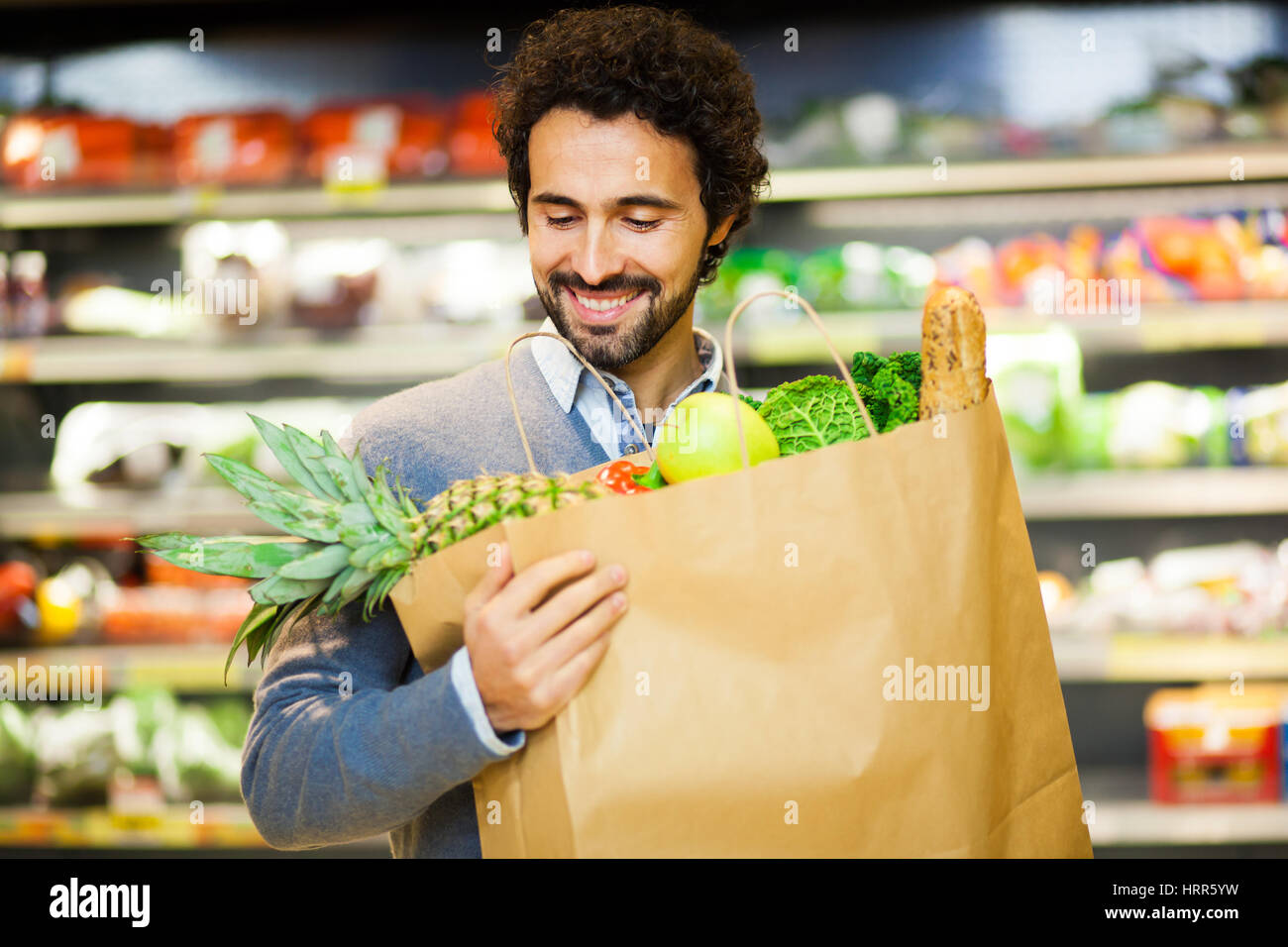 Handsome man shopping in a supermarket Stock Photo - Alamy