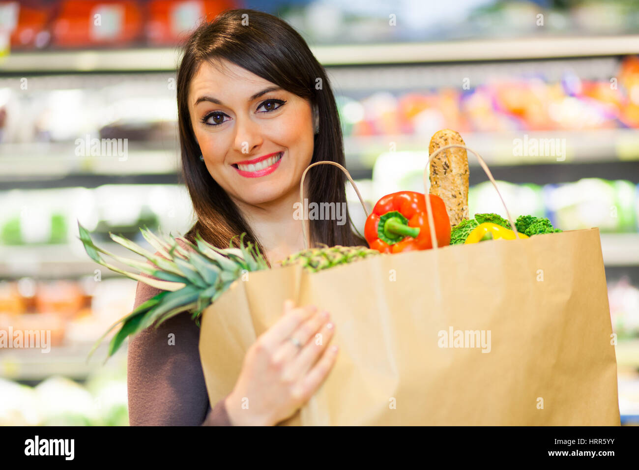 Smiling woman shopping in a supermarket Stock Photo - Alamy