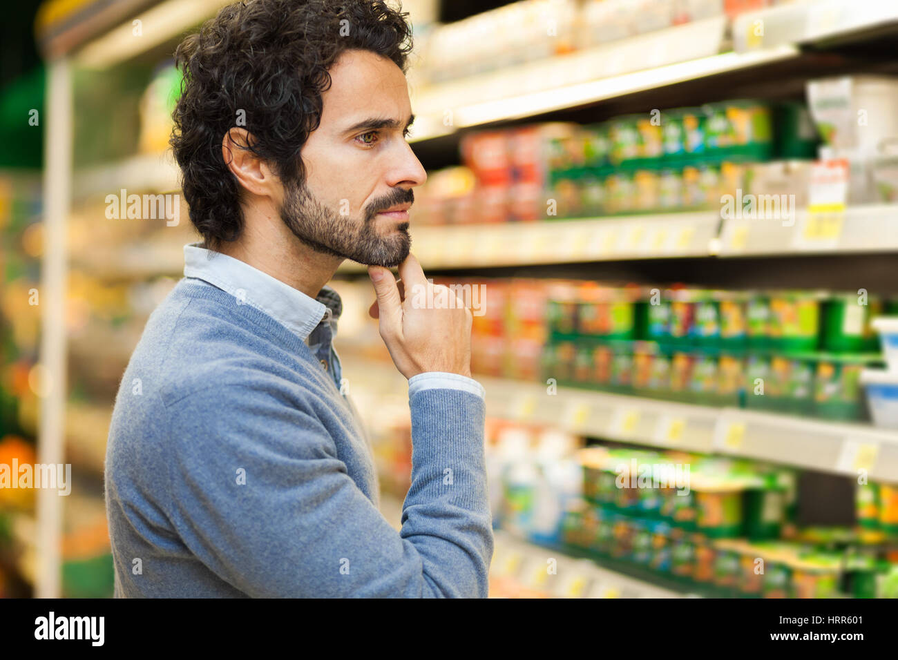 Attractive man shopping in a supermarket Stock Photo - Alamy