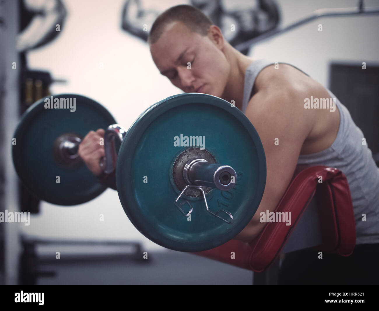 side view of muscular man holding barbell in gym. Focus on barbell ...