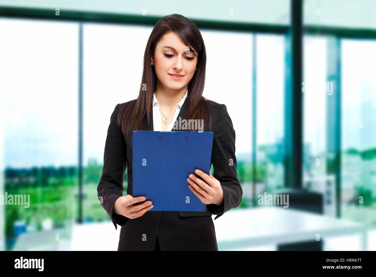 Young beautiful business woman reading documents Stock Photo - Alamy