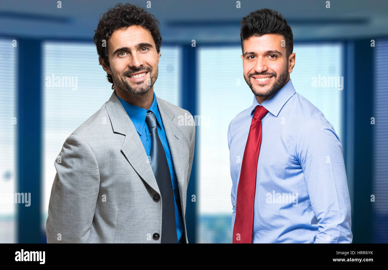 Two businessman sharing an office Stock Photo - Alamy
