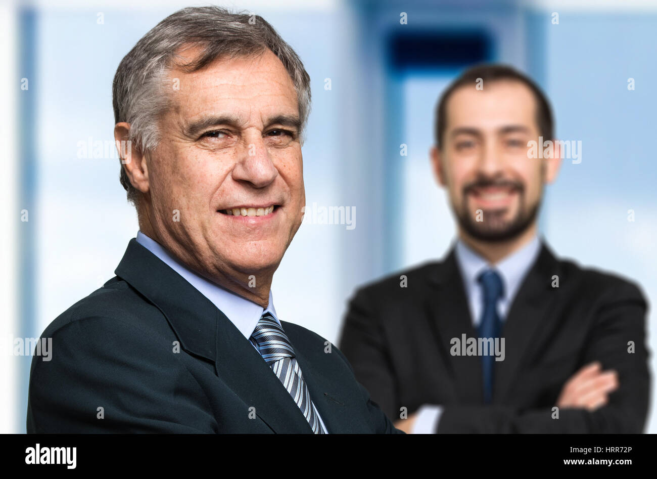 Smiling businessman in front of his boss Stock Photo - Alamy