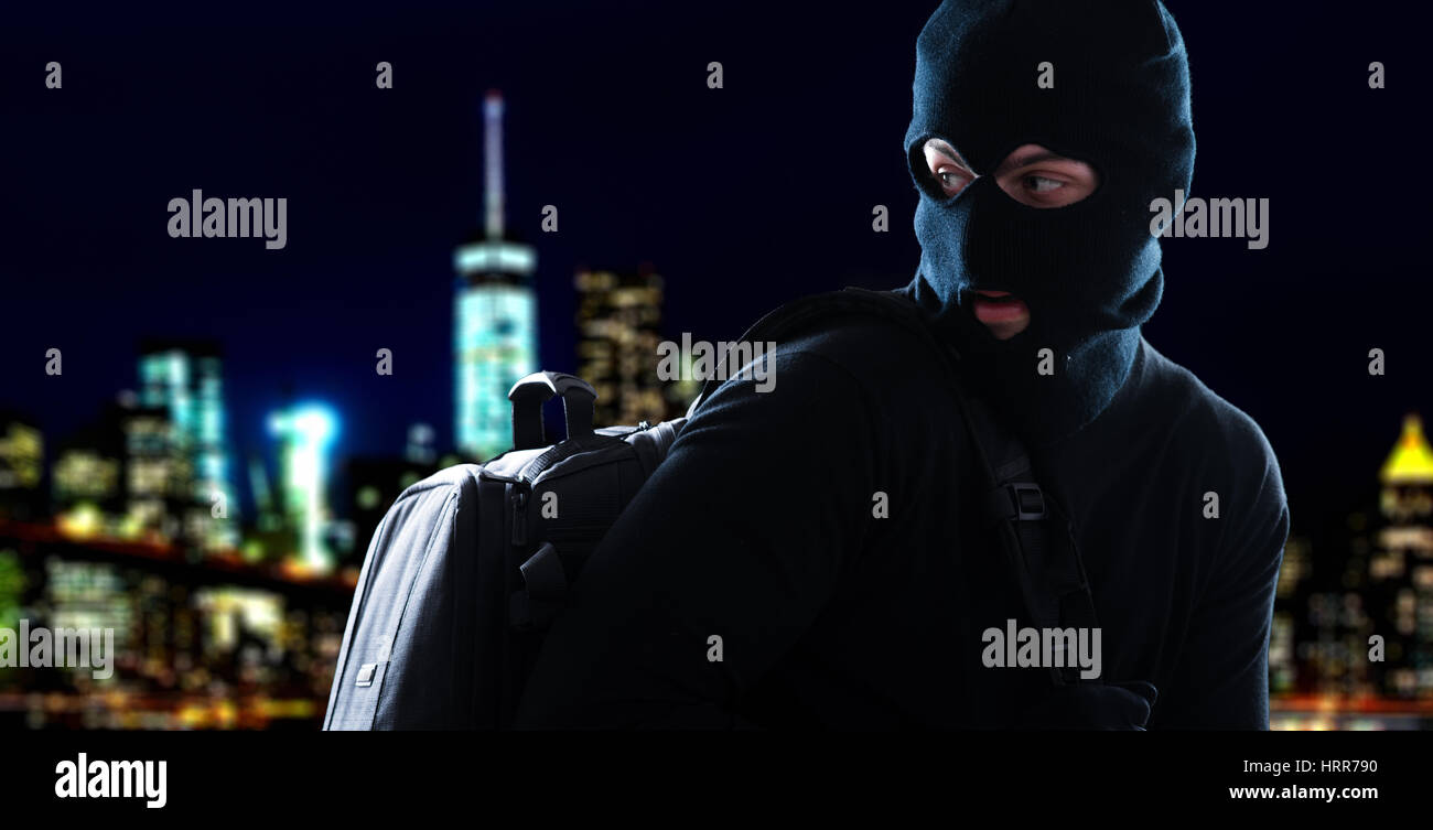 Thief escaping in the night Stock Photo - Alamy