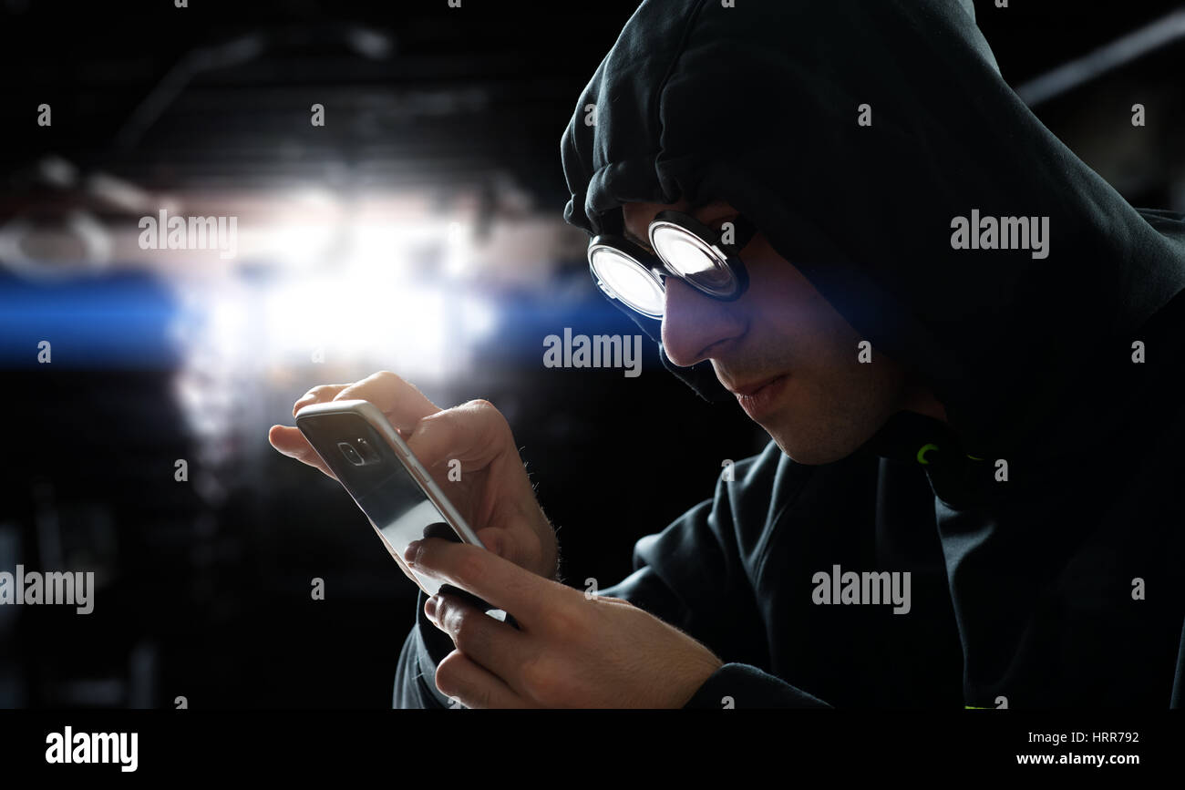 Hacker touching a smart phone screen Stock Photo - Alamy