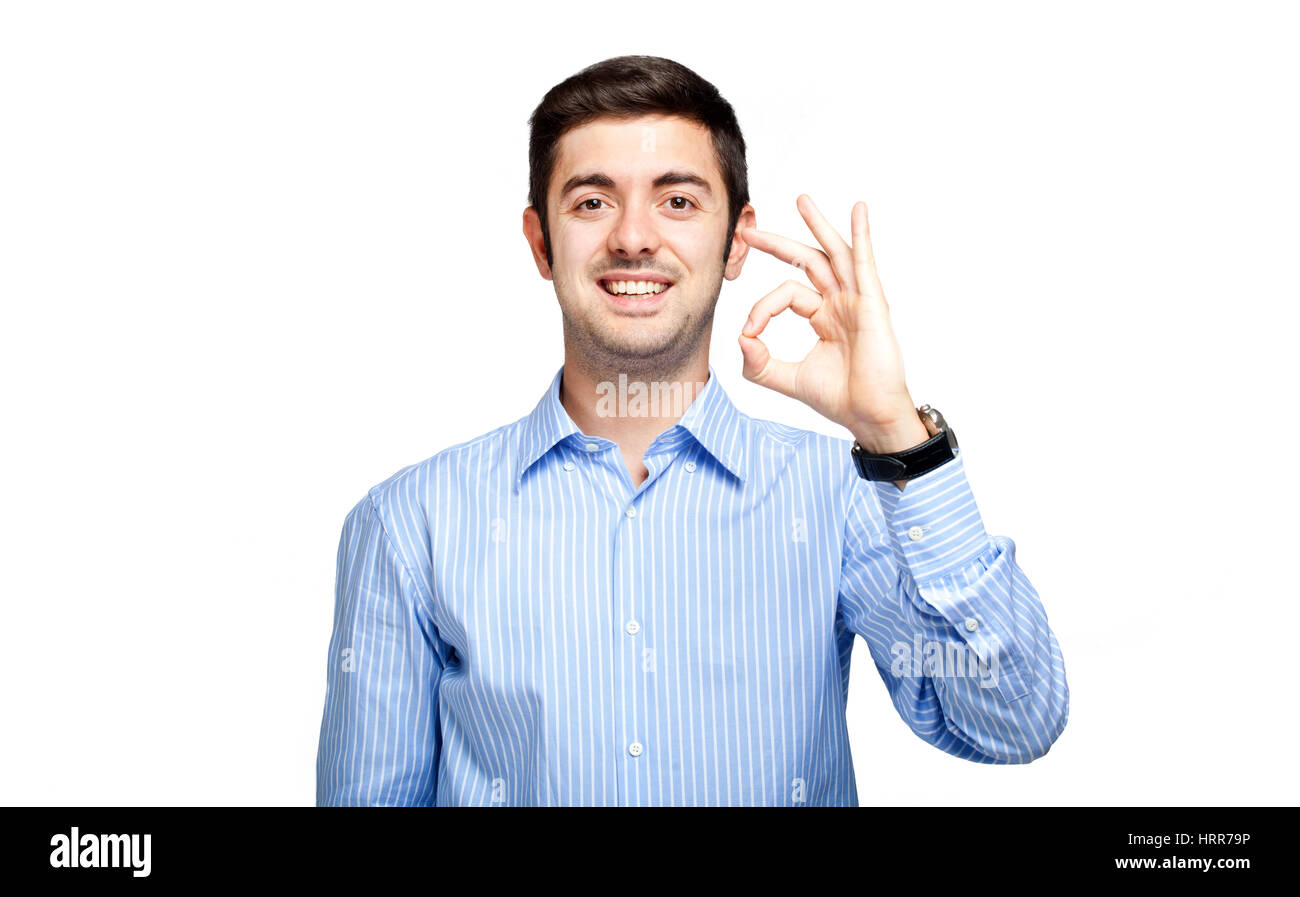 Young man showing ok sign isolated on white Stock Photo - Alamy
