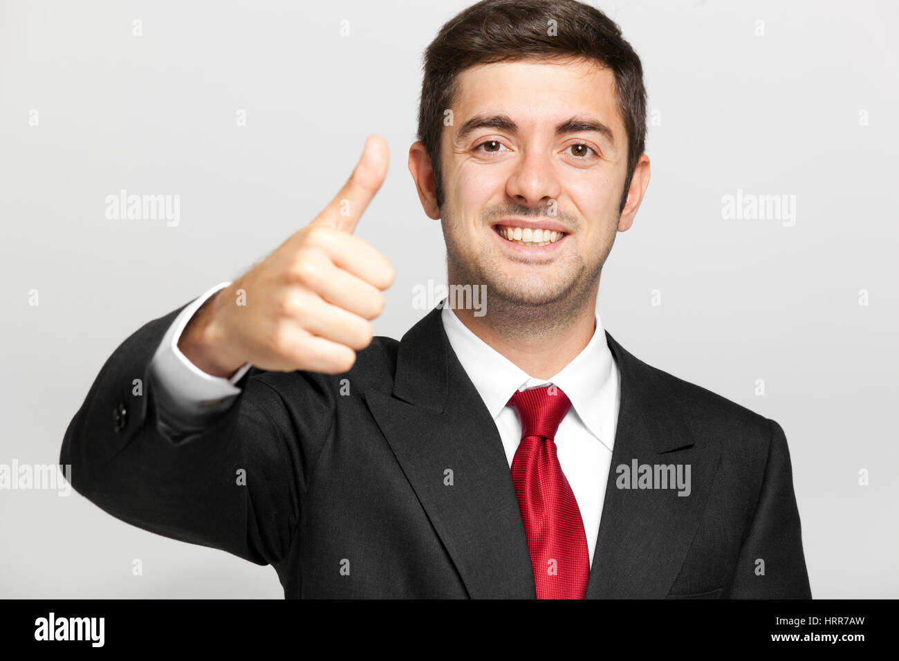 Male manager thumbs up on white background Stock Photo - Alamy