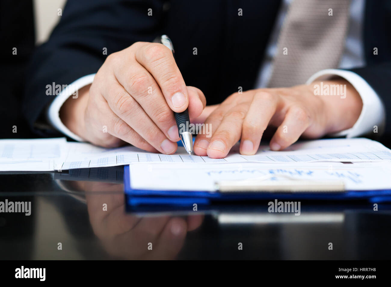 Closeup of a businessman's hand while writing some documents Stock ...