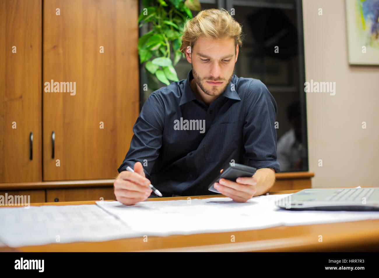 Portrait of a man at work in his office Stock Photo - Alamy